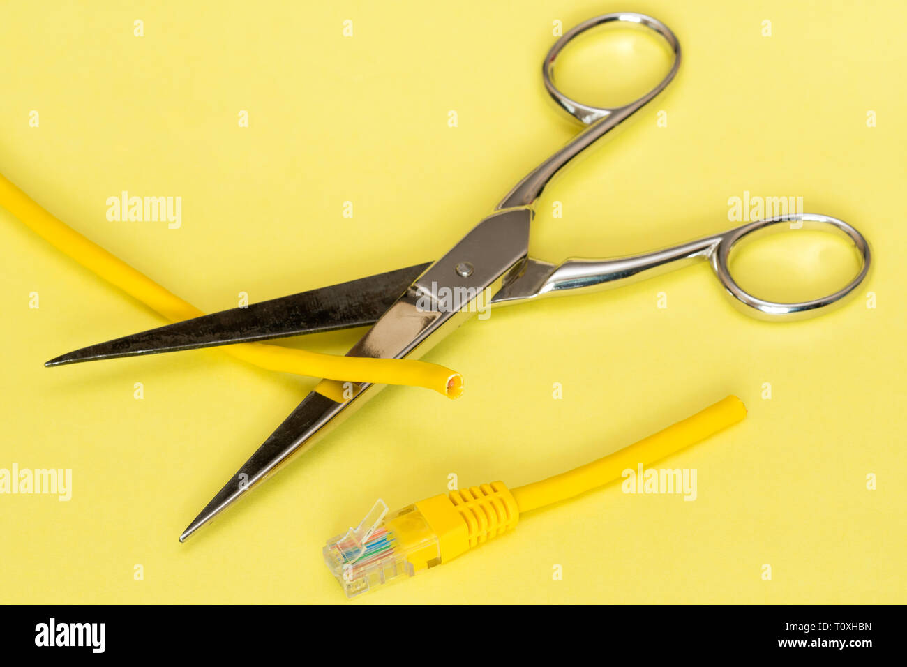 Internet censorship concept. Yellow Internet cable cut by scissors ...