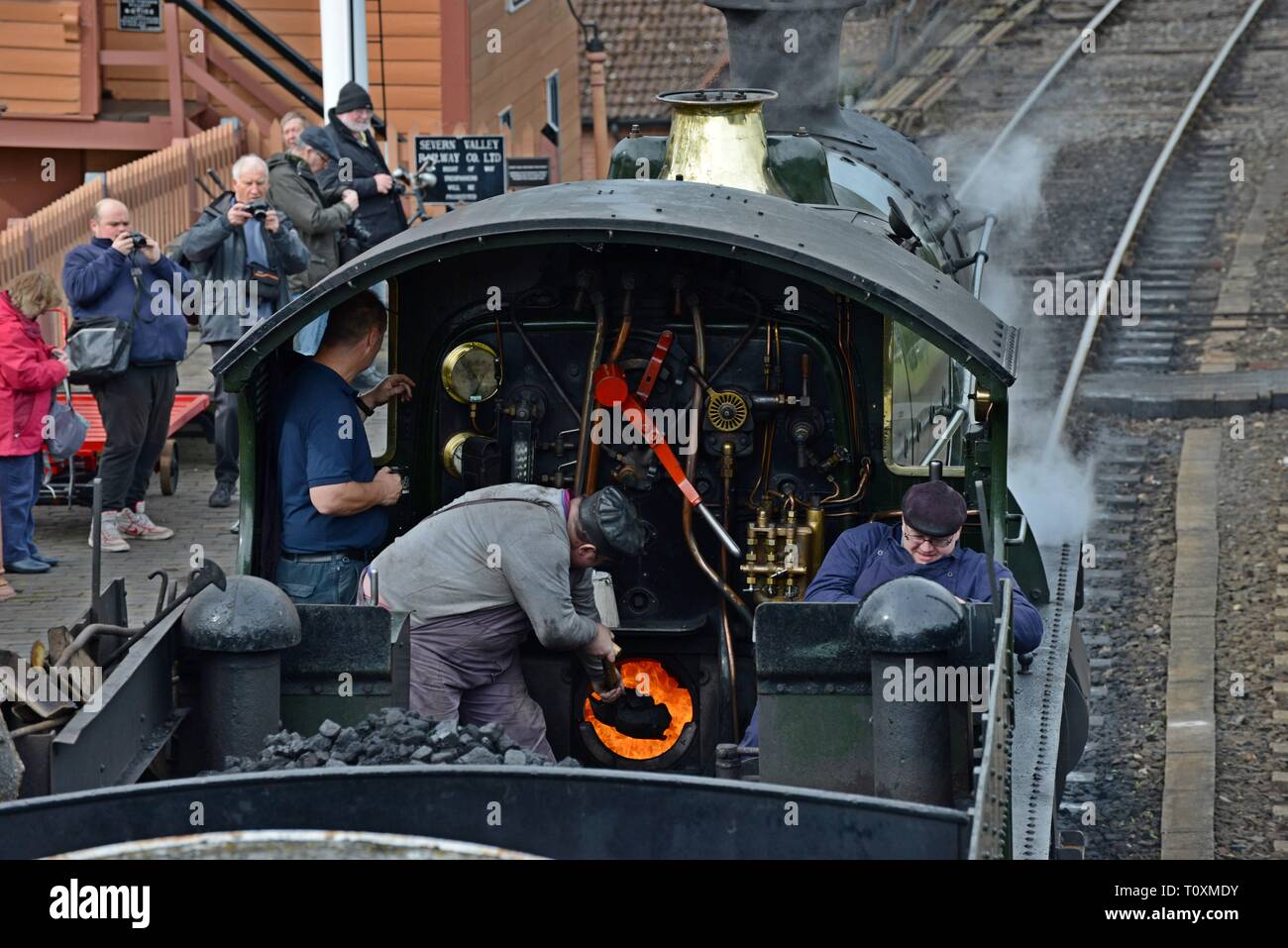 A locomotive fireman stokes Great Western steam locomotive 2857 at ...