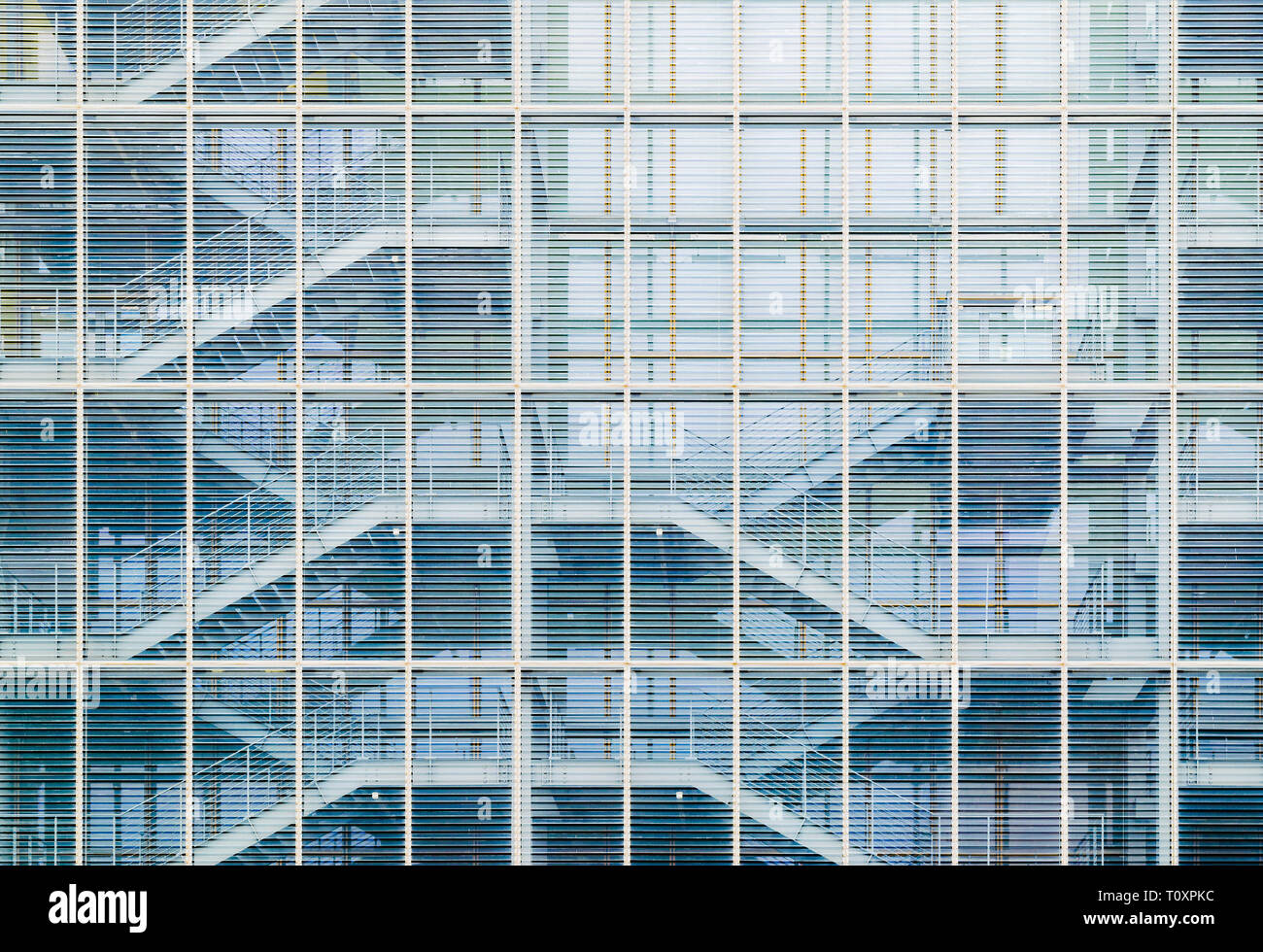 The facade of a modern building with glass windows and flights of ...