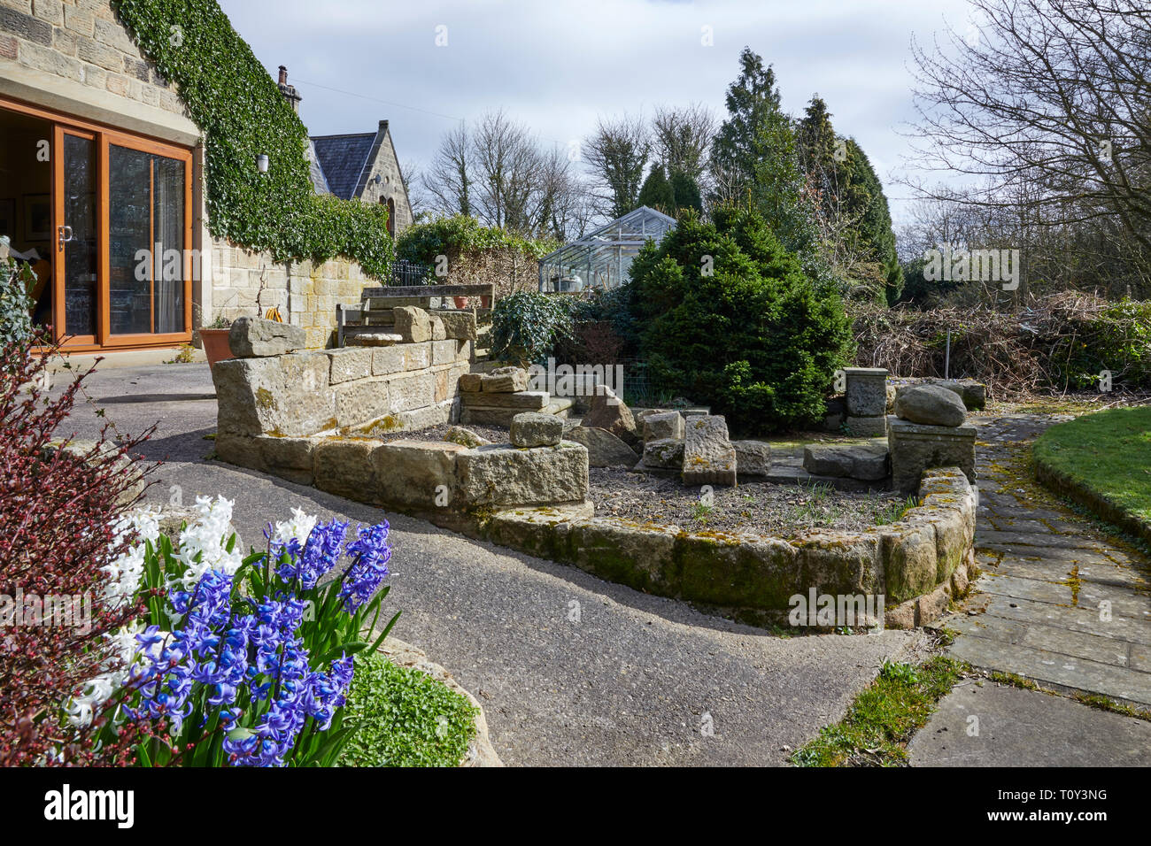With greenhouse, rockery, stones. and hyacinths in need of attention ...