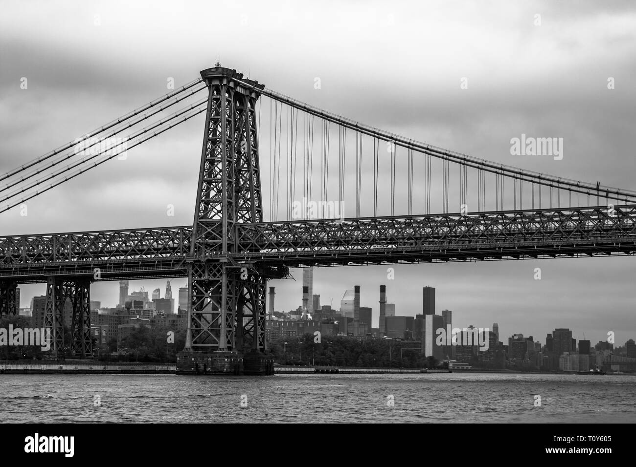 The Williamsburg Bridge, a suspension bridge in New York City, crosses the East River connecting ...