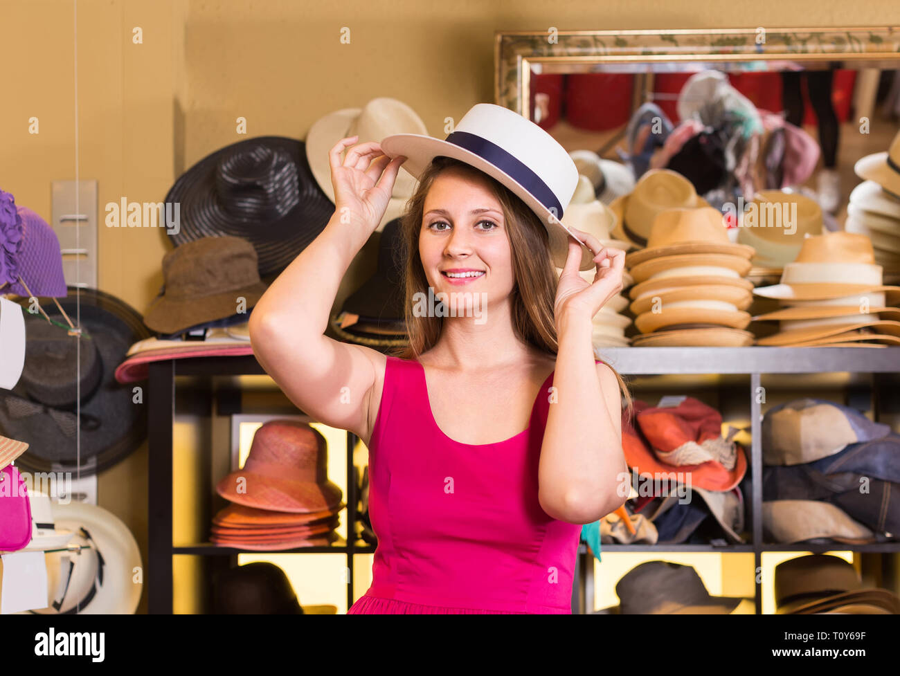 adult happy woman try on hatinator hat in shopping mall Stock Photo - Alamy