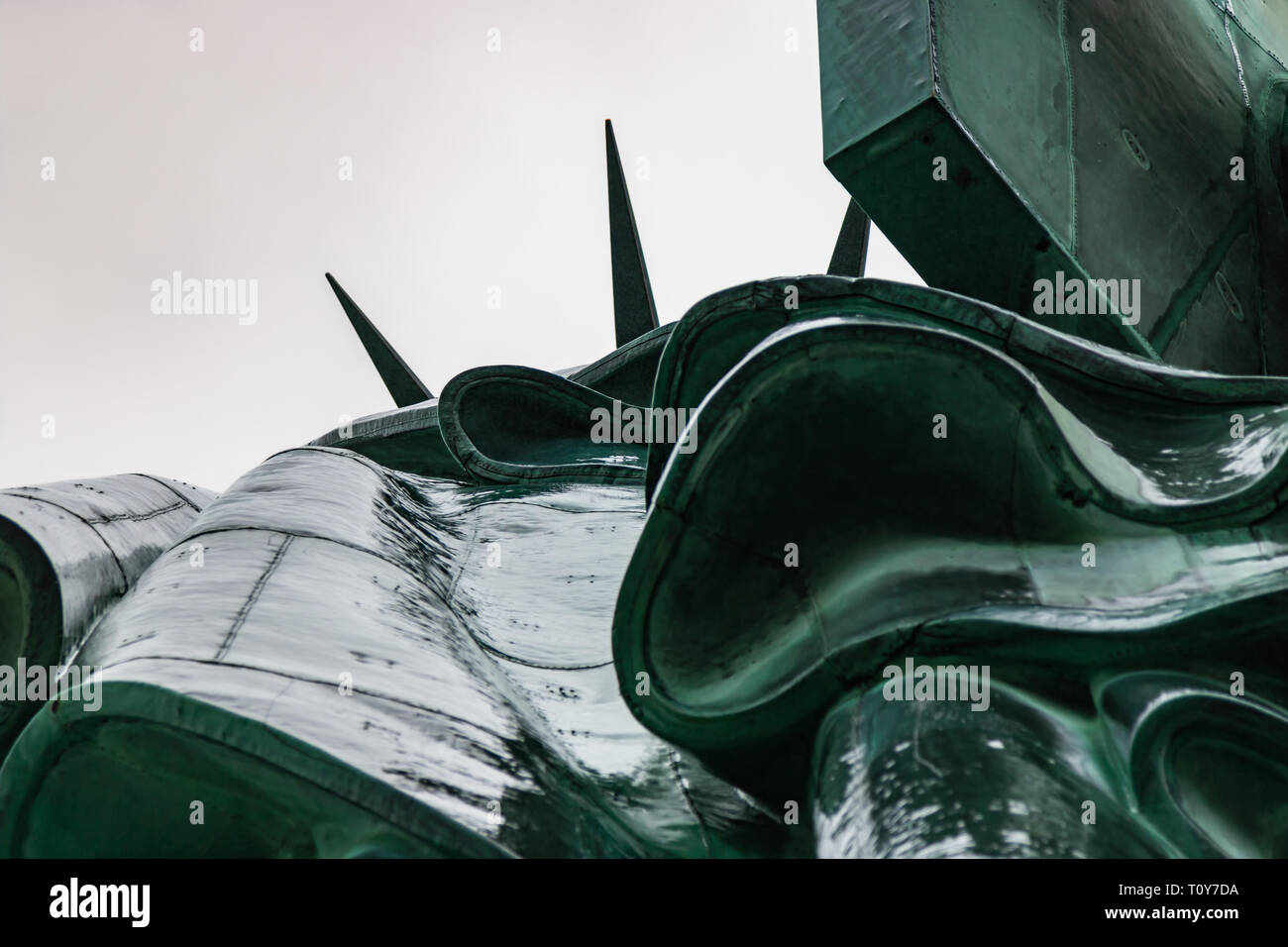 A close up of a rain-wet Statue of Liberty focussing on her robes and ...