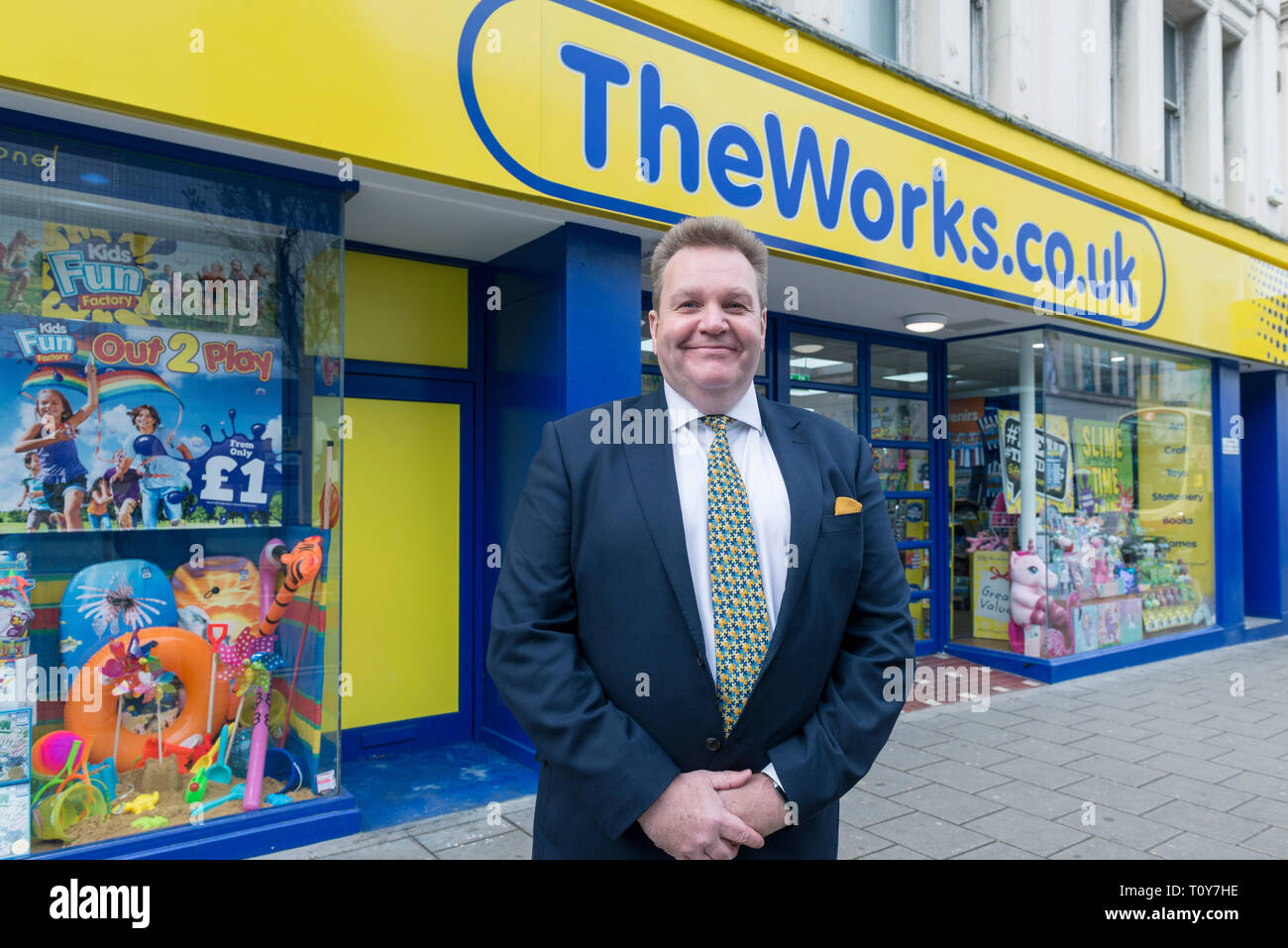The CEO / boss / manager of The Works stands outside the store in a ...