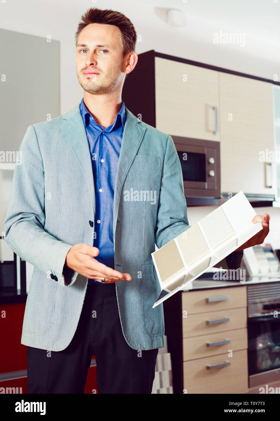 Salesman of furniture accessories store showing variants of stone for ...