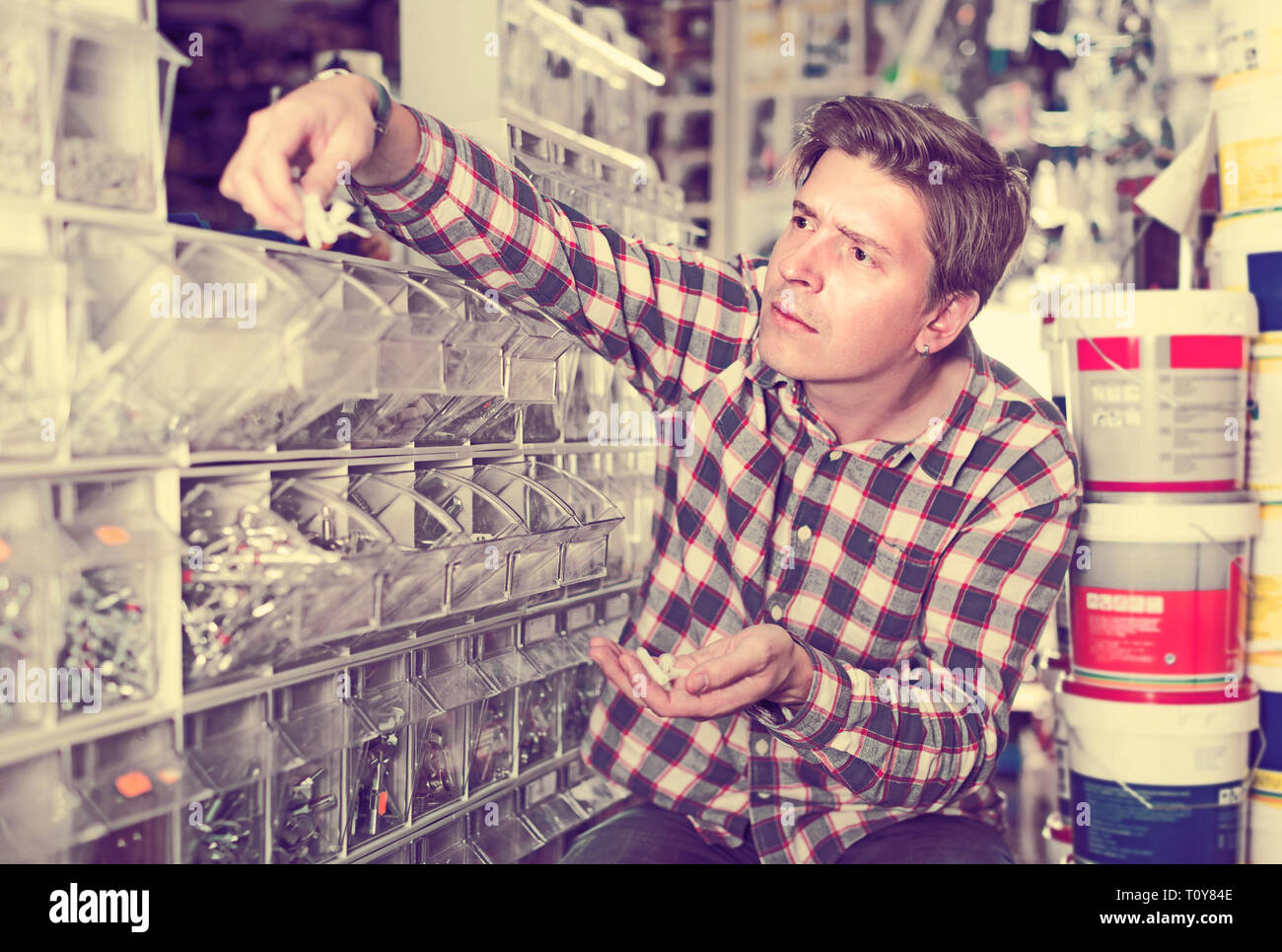 Portrait of adult male in hardware store buying goods for repair Stock ...