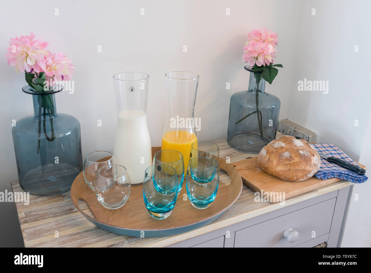 breakfast food and drink is laid out in a hotel ready for the guests ...