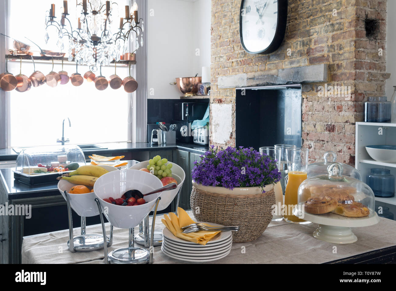 breakfast food and drink is laid out in a hotel ready for the guests ...