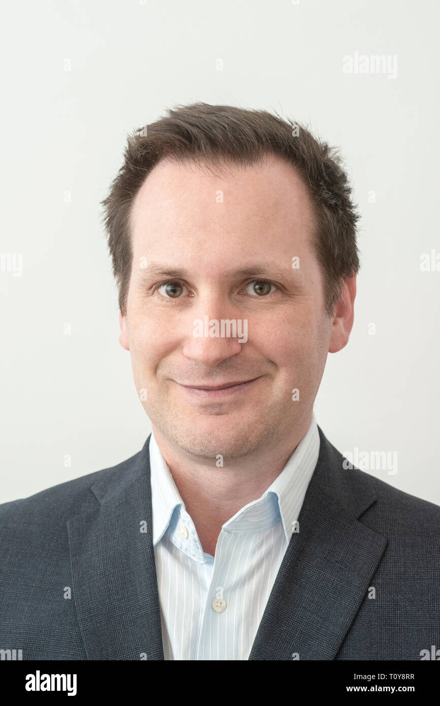 a real business man stands in front of a white background Stock Photo ...