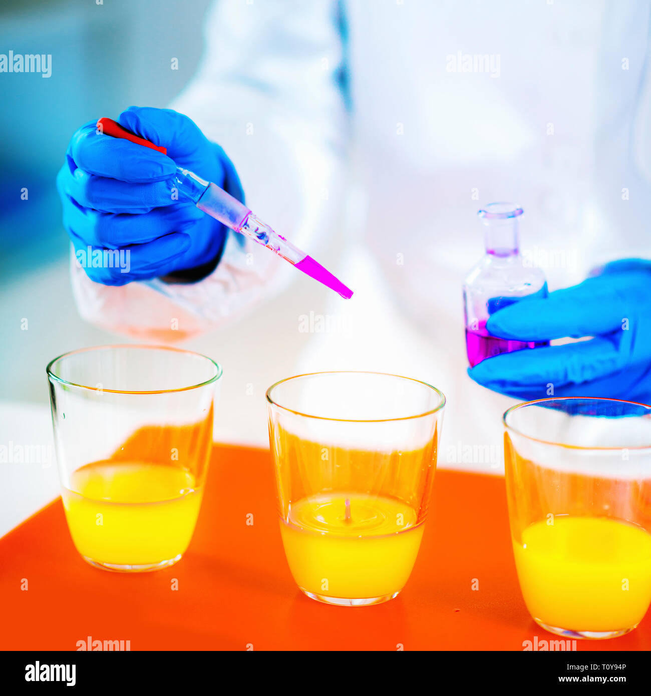 Quality control expert inspecting juice in the laboratory Stock Photo ...