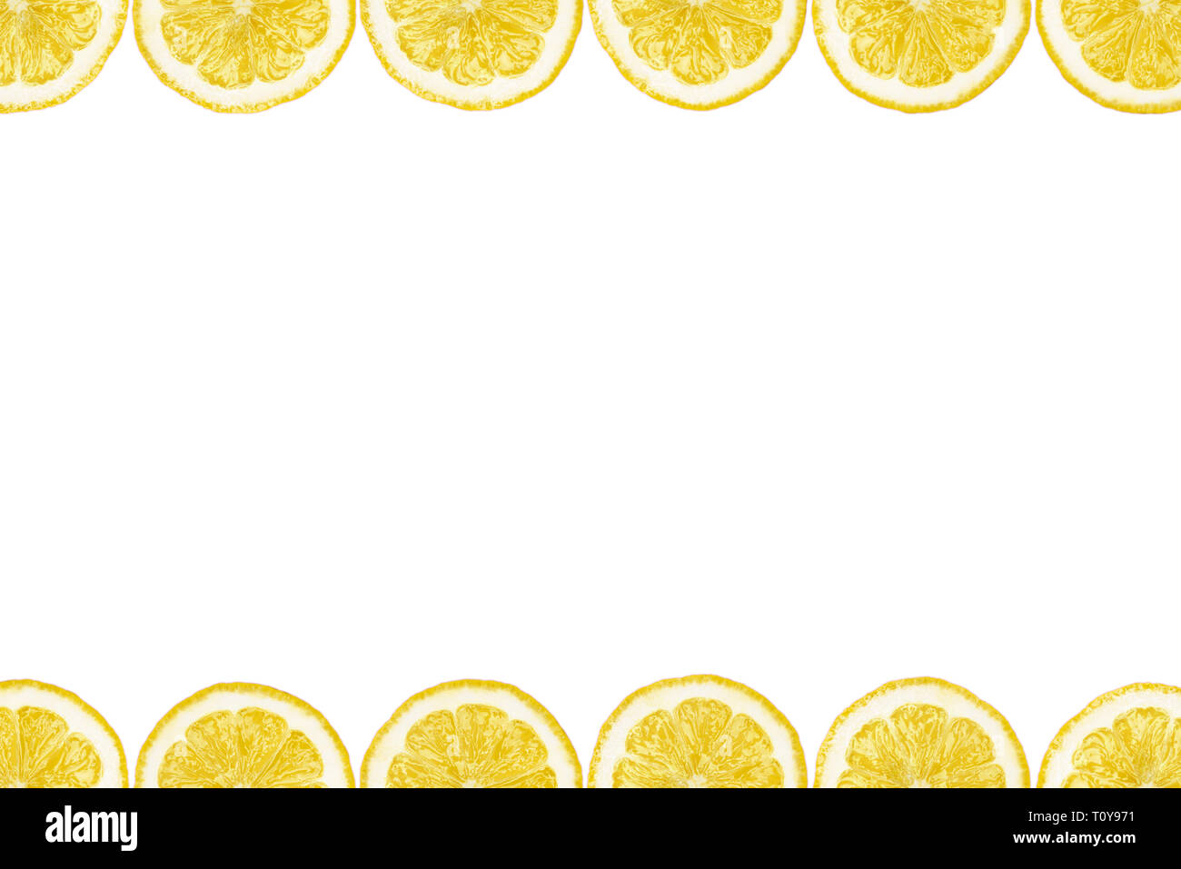 Pattern made from fresh lemon slices on a white background with copy space in the middle ...