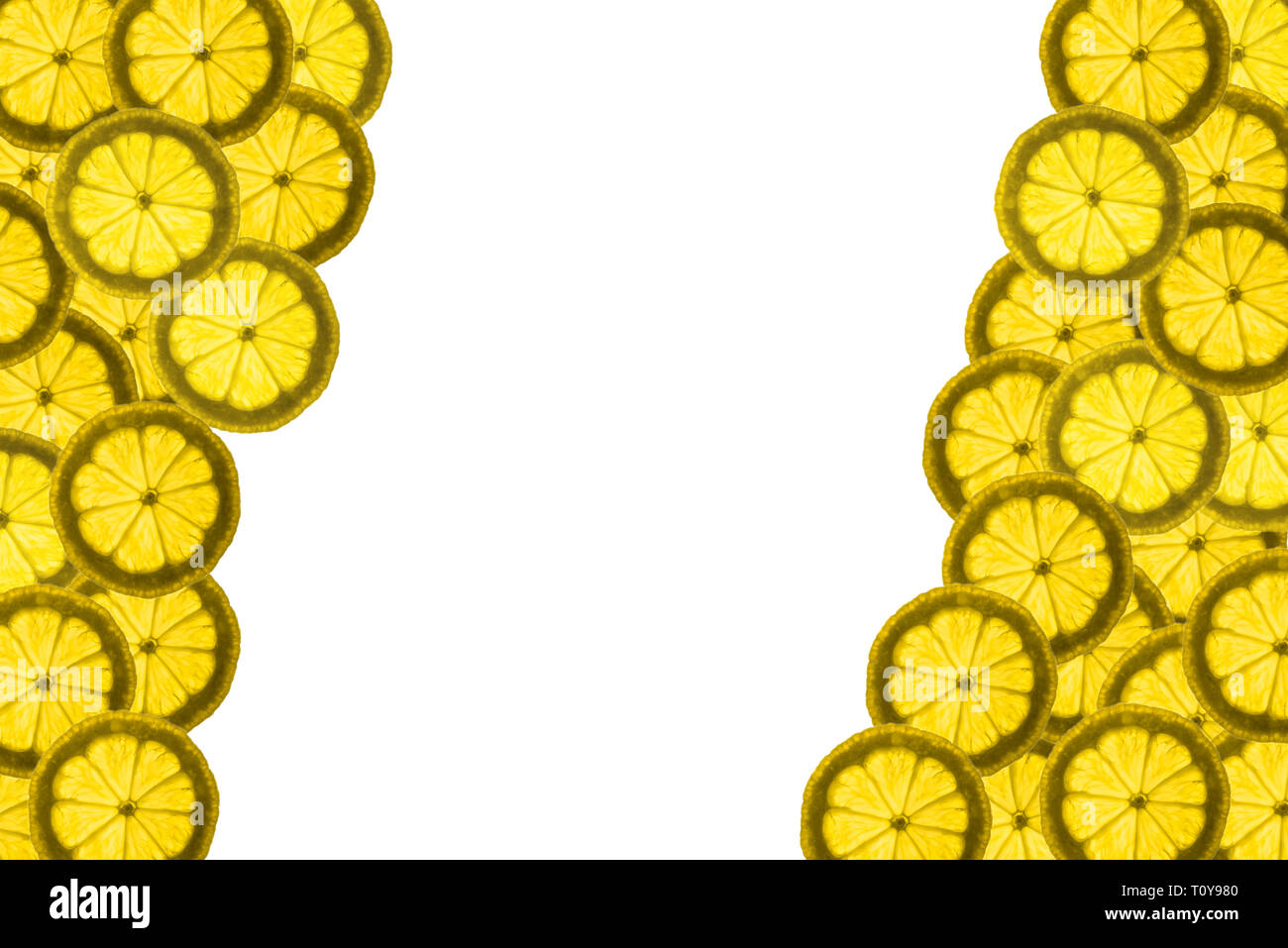 Pattern made of lemon slices illuminated with light from the bottom on a white background with ...