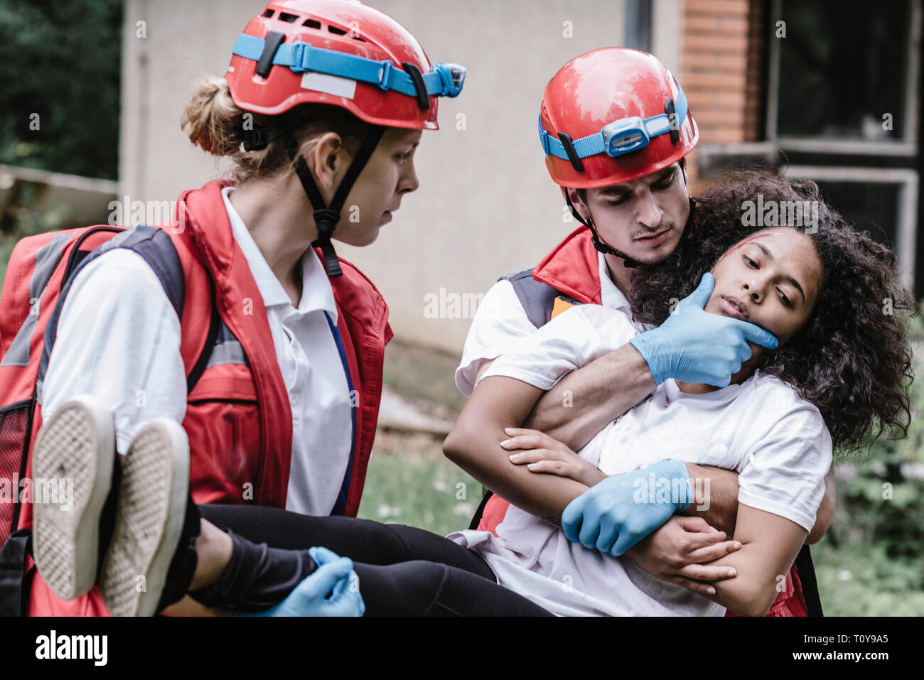Rescue team evacuating woman from disaster area Stock Photo - Alamy