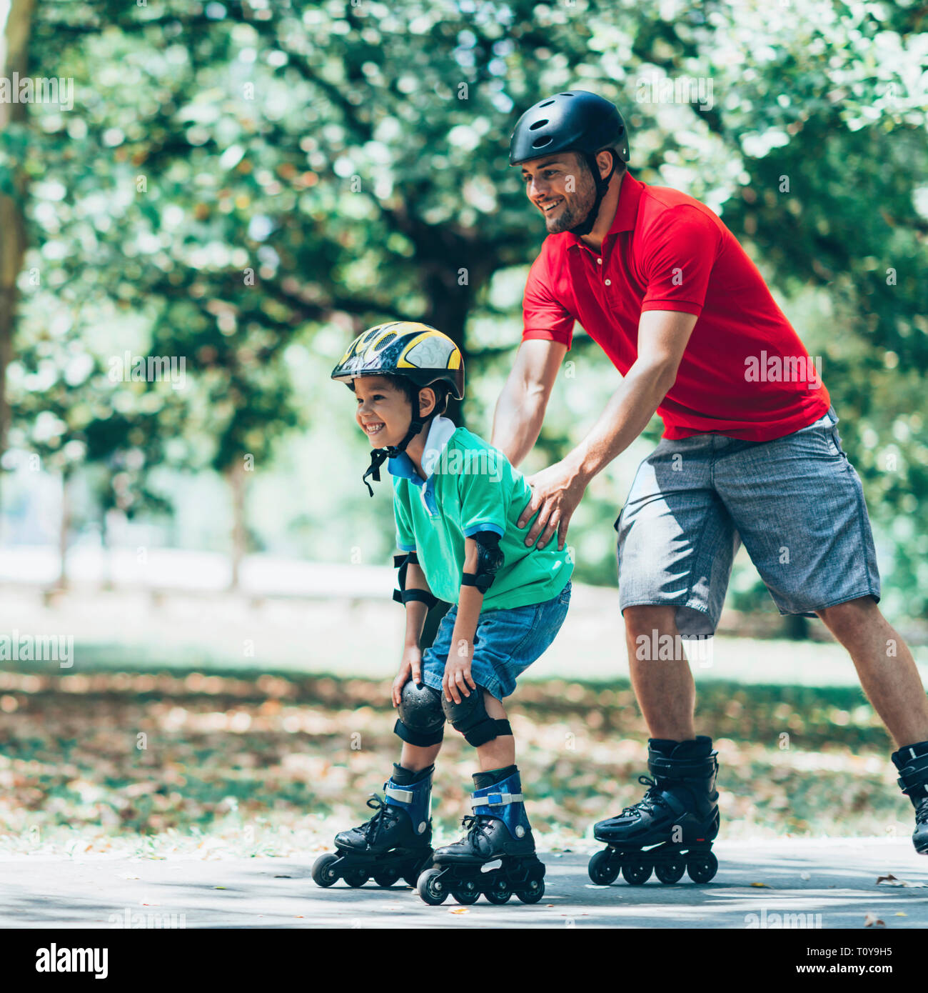Family with one child roller skating Stock Photo - Alamy