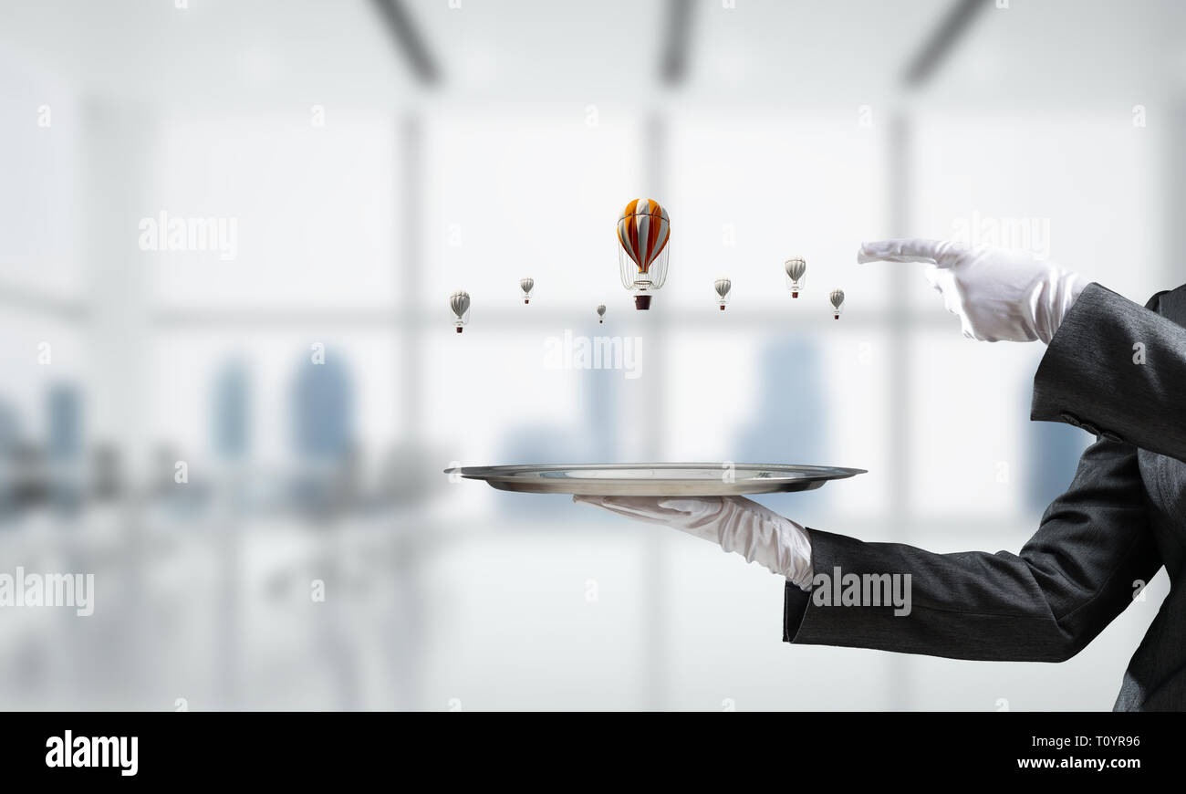 Hand of waiter presenting balloons on tray Stock Photo - Alamy