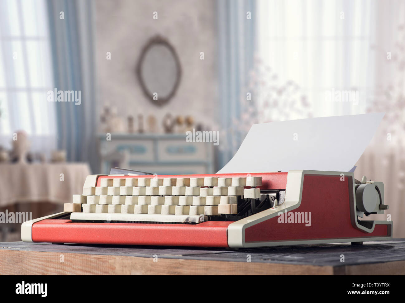 Red vintage typewriter in retro interior in blue tones Stock Photo - Alamy
