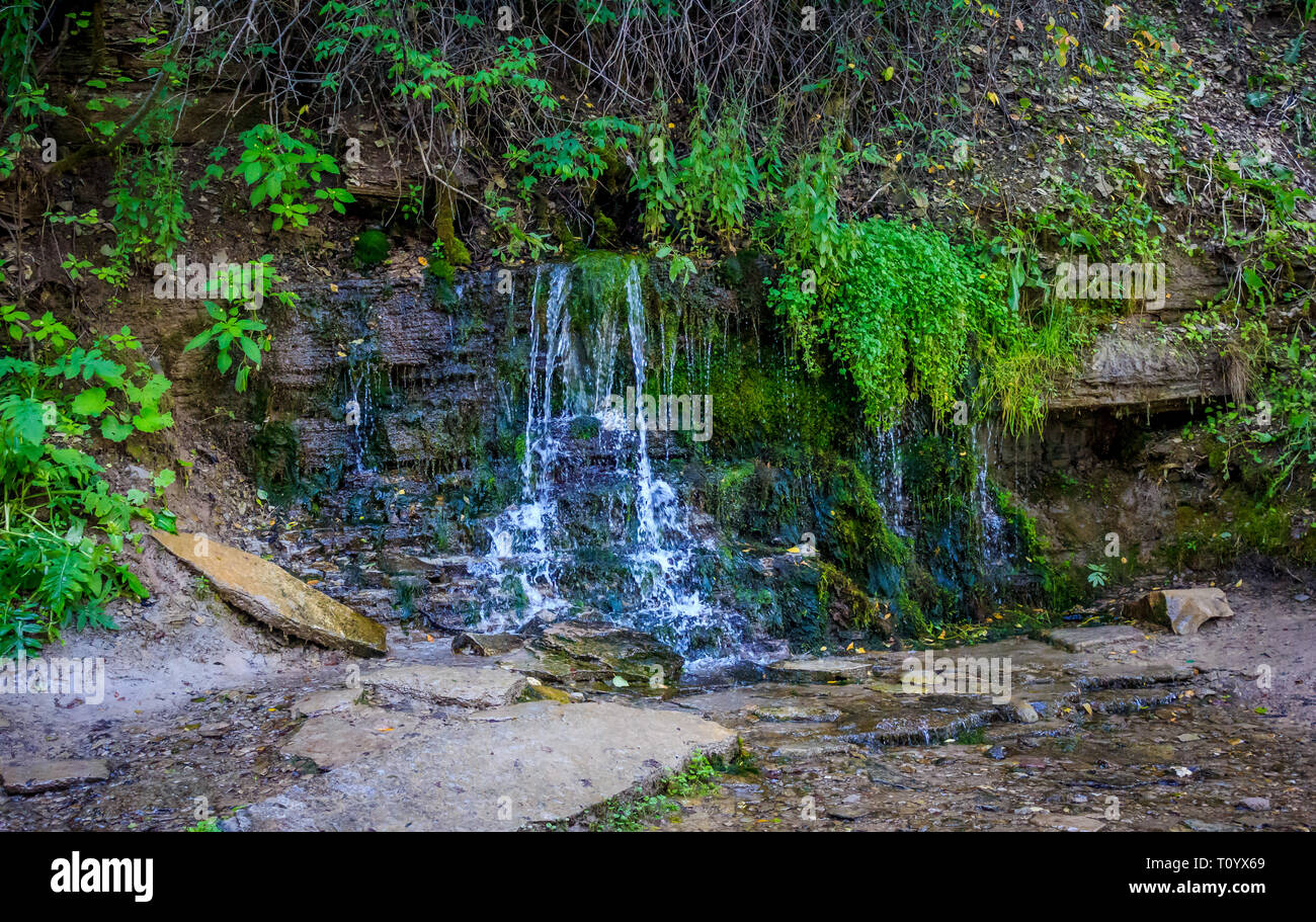 A small waterfall. Waterfalls in the outback of Russia. Water flows ...