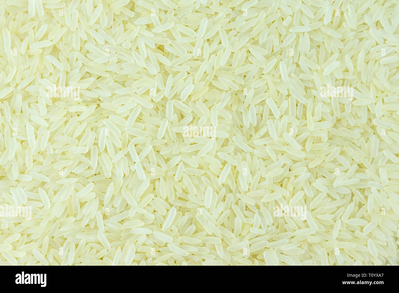 A full page of uncooked rice background texture Stock Photo - Alamy