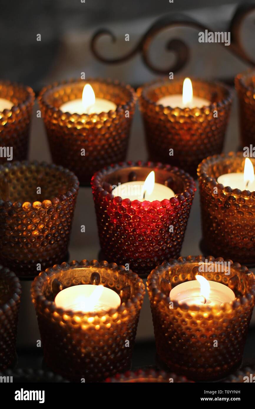 Lit candles in a cathedral Stock Photo - Alamy