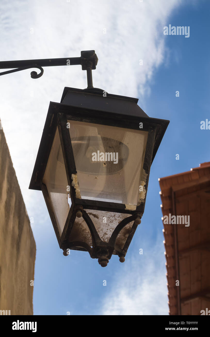 Traditional street lamp - lantern with a modern bulb, hanging from a ...
