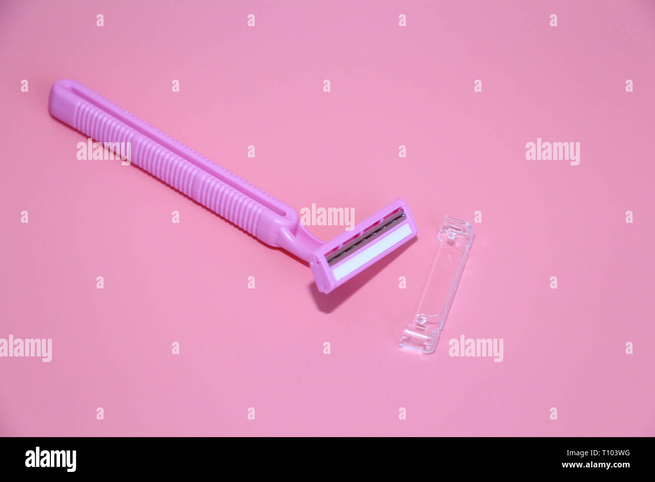 One razor is lying on a pink background. Pink razor on a pink ...