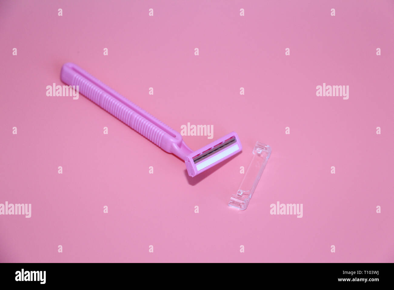 One razor is lying on a pink background. Pink razor on a pink ...