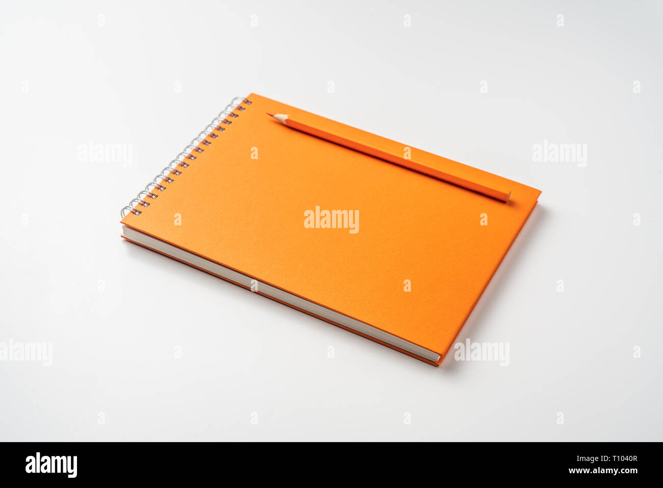 Design concept - perspective view of spiral orange notebook isolated on ...
