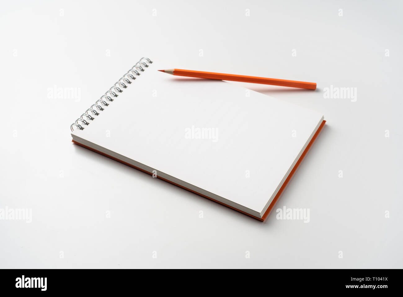 Design concept - perspective view of spiral orange notebook isolated on ...