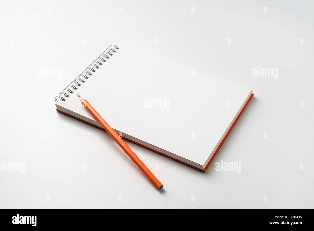 Design concept - perspective view of spiral orange notebook isolated on ...