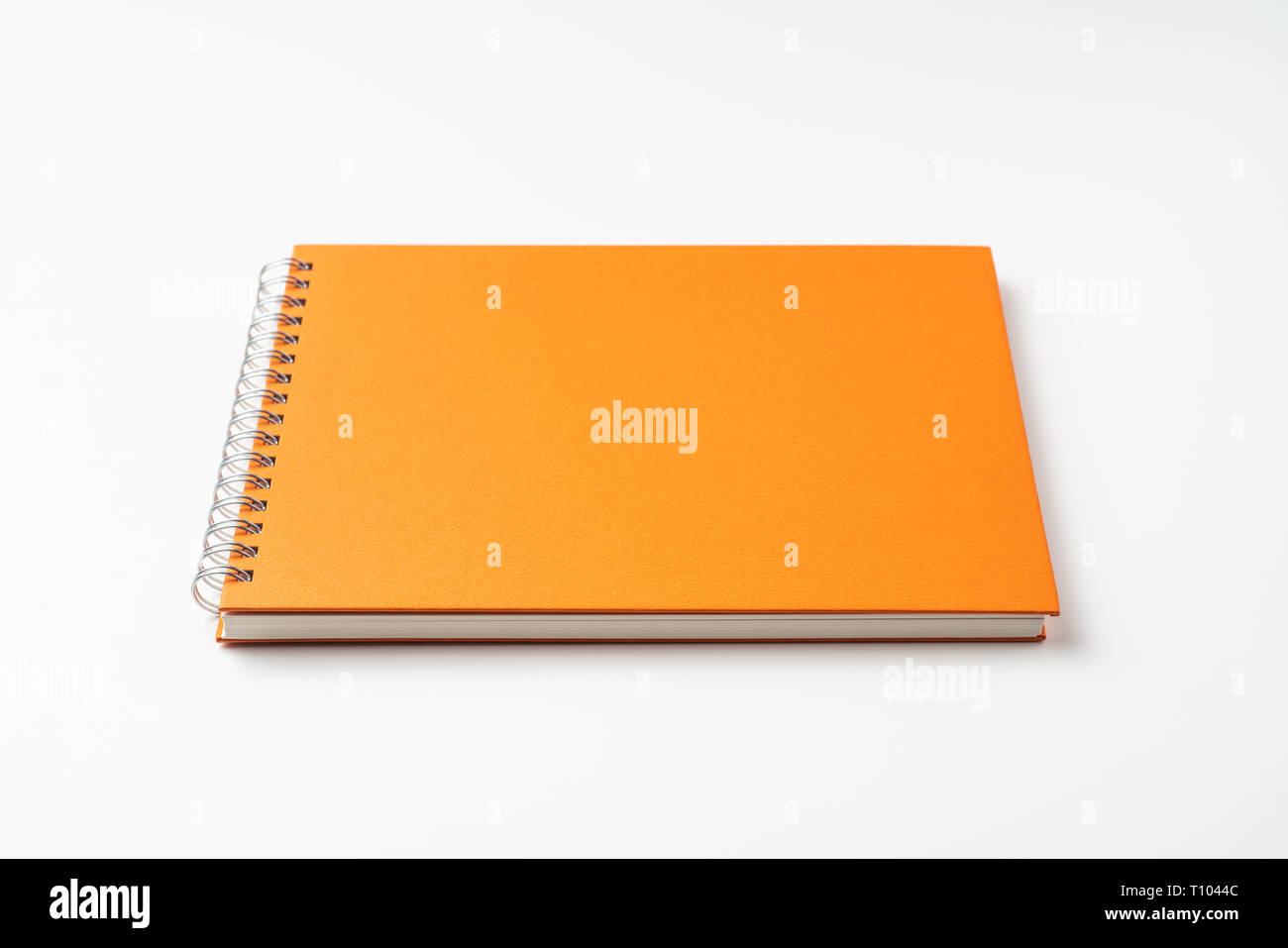Design concept - perspective view of spiral orange notebook isolated on ...