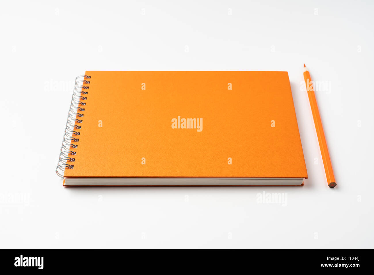 Design concept - perspective view of spiral orange notebook isolated on ...