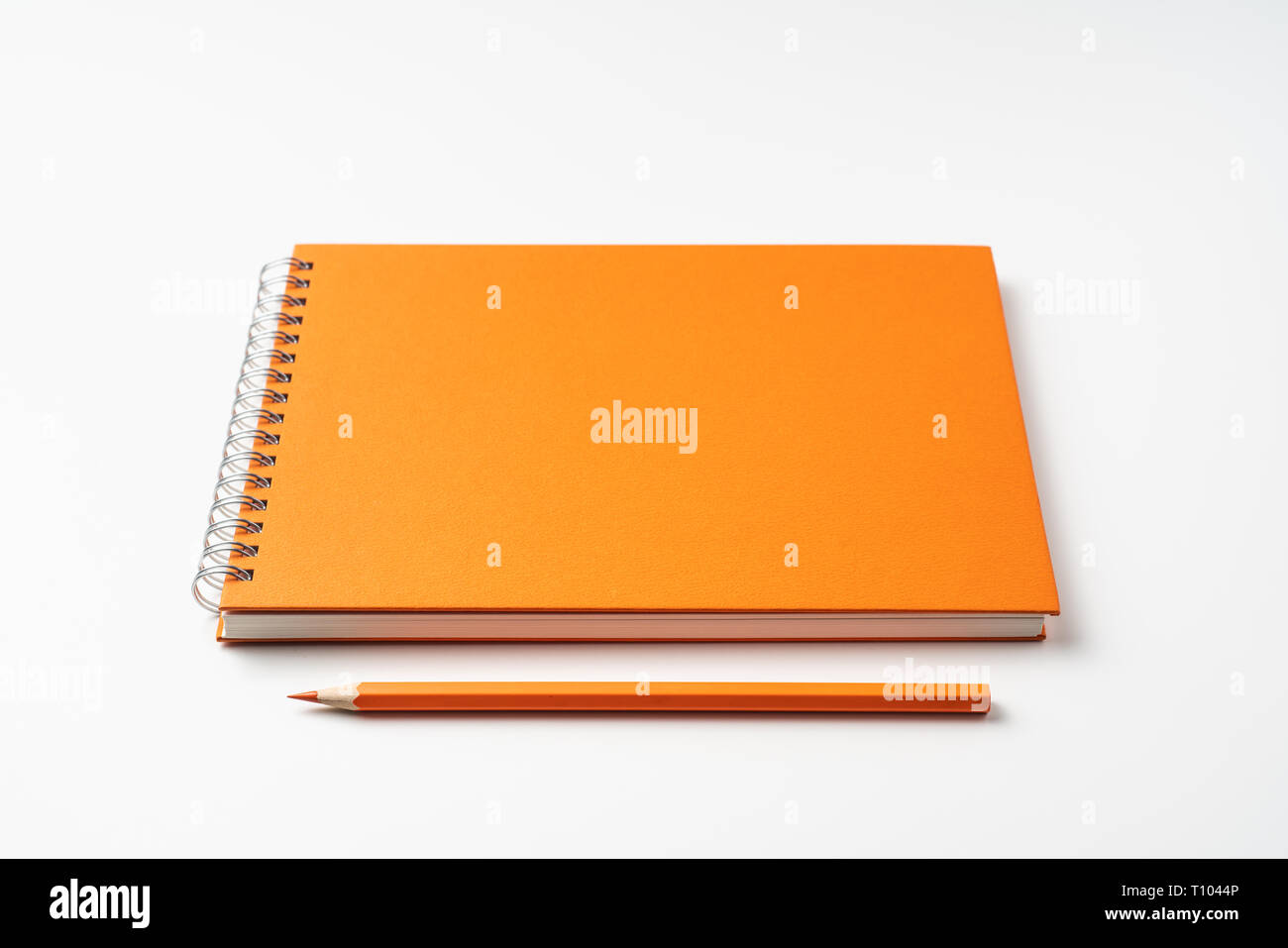 Design concept - perspective view of spiral orange notebook isolated on ...