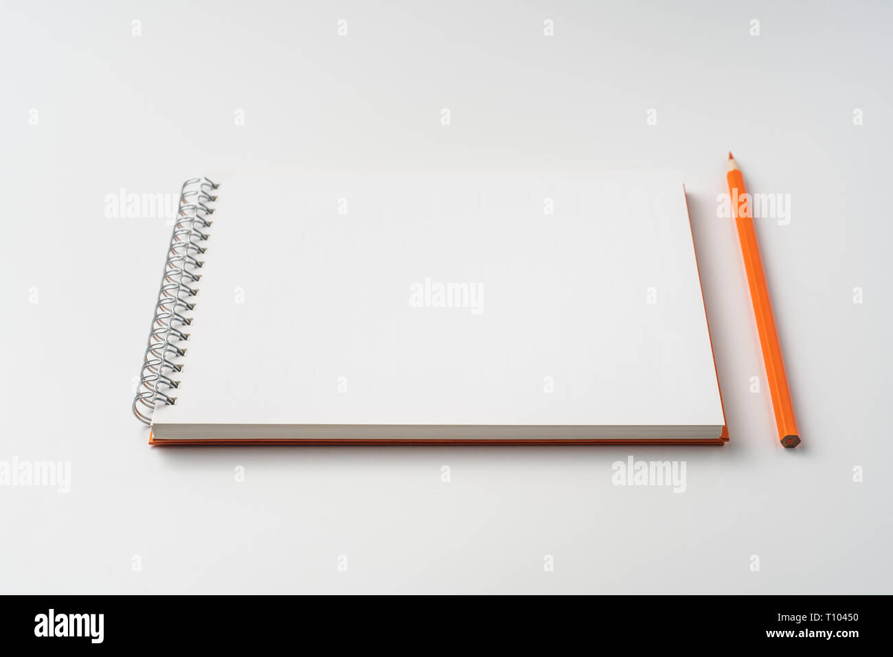 Design concept - perspective view of spiral orange notebook isolated on ...