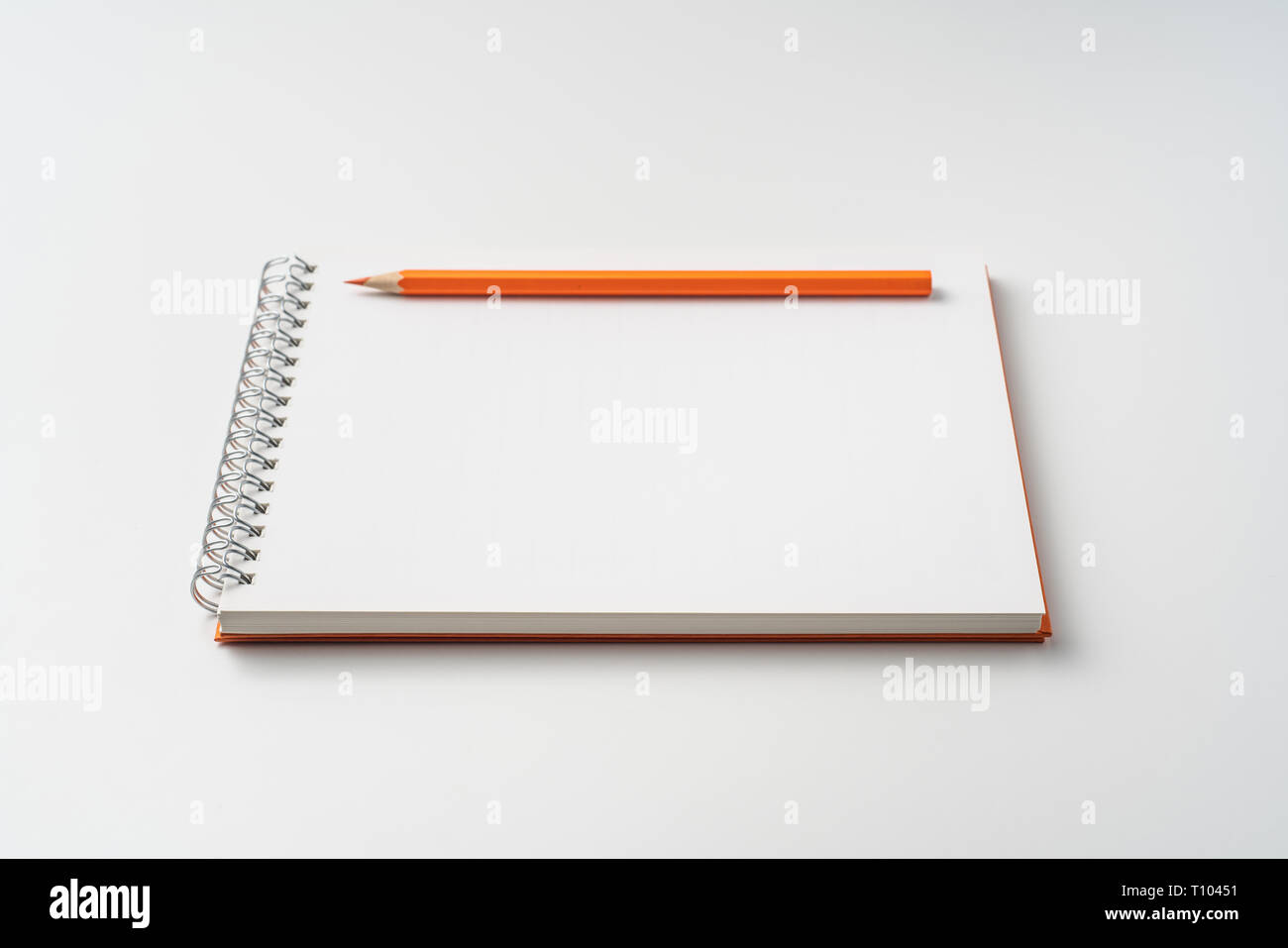 Design concept - perspective view of spiral orange notebook isolated on ...