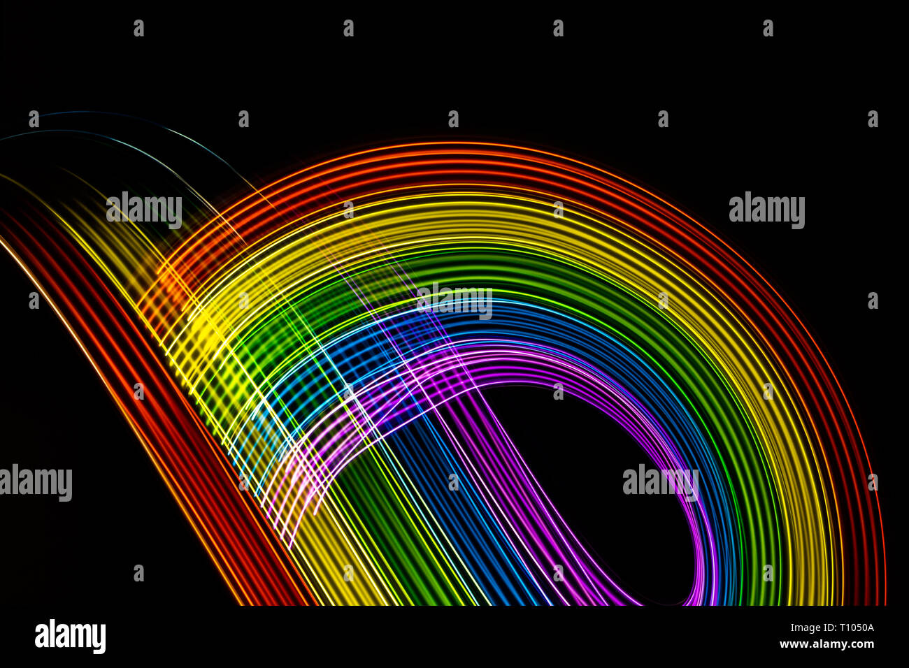 Multicolor lights on black background. Rainbow of vibrant colors curves ...