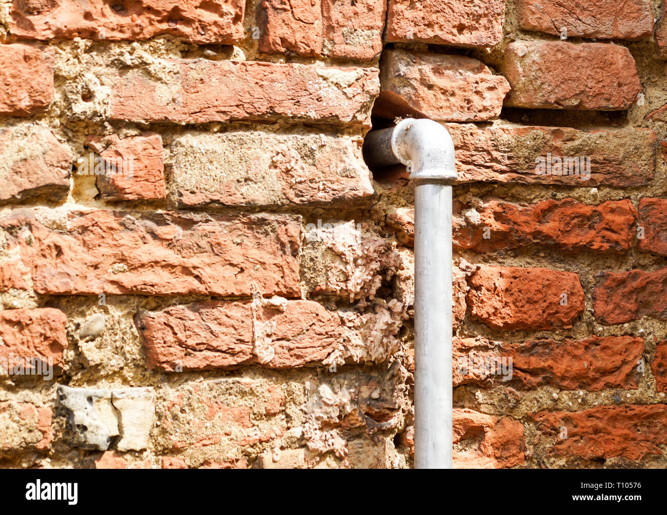 White pipe on wall background, pipe for water system and electricity ...