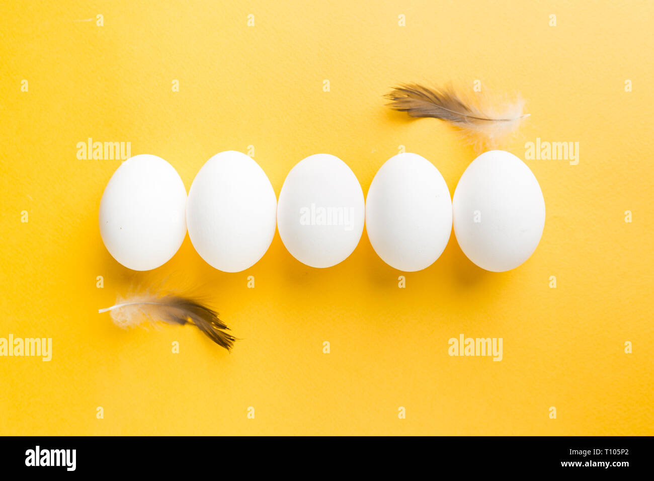 Set of white eggs on the yellow background in center. Pop art design ...
