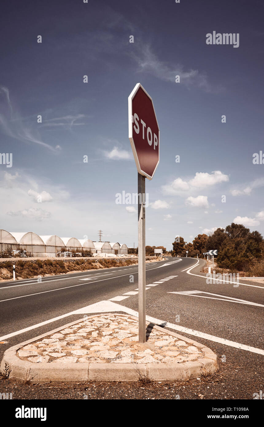 Stop sign at road crossing, color toned picture Stock Photo - Alamy