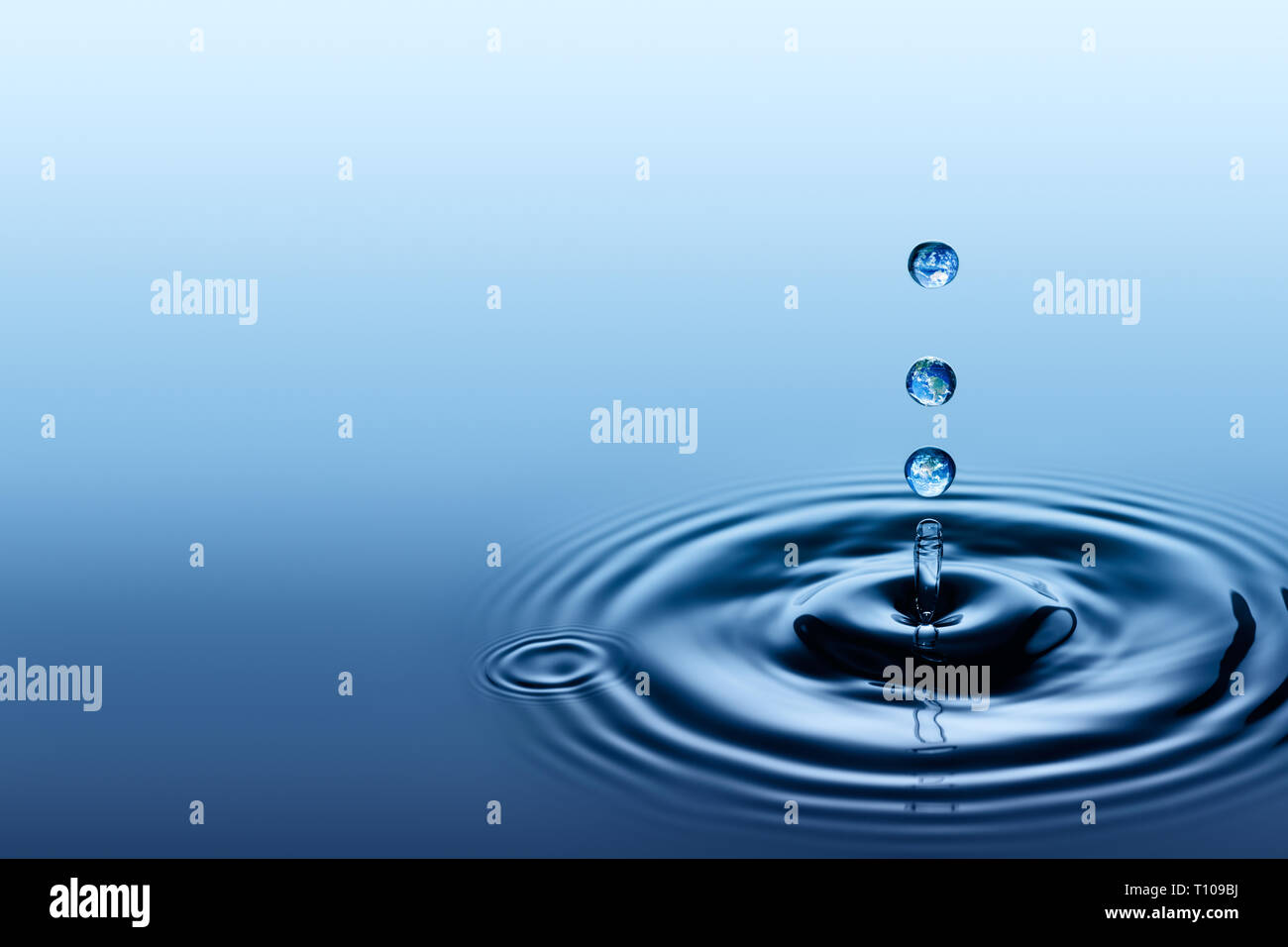 Drops of rain with earth picture falling on smooth water surface Stock ...