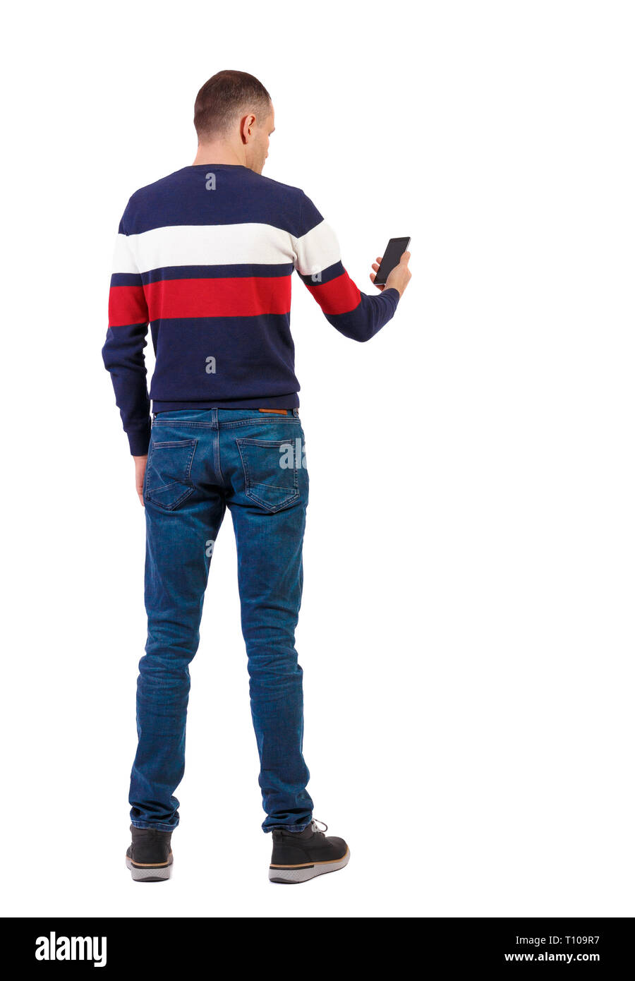 Back view of man who is looking into the smartphone. rear view people ...