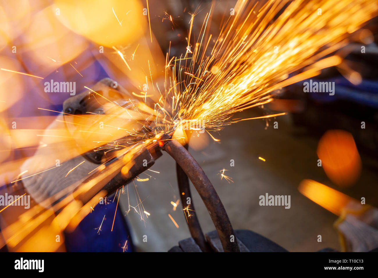 Bright orange and yellow sparks on a black background. A stream of ...