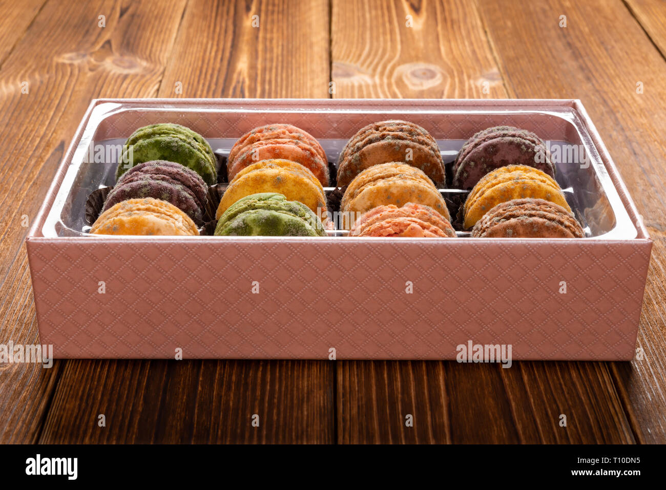 side view box of moldy macaroons on a wood table Stock Photo - Alamy