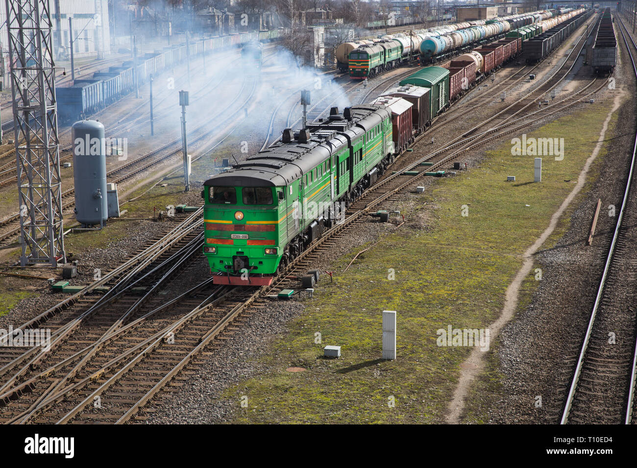 City Riga, Latvia. Railway with cargo locomotive with wagons. Many iron ways and trains. Freight ...