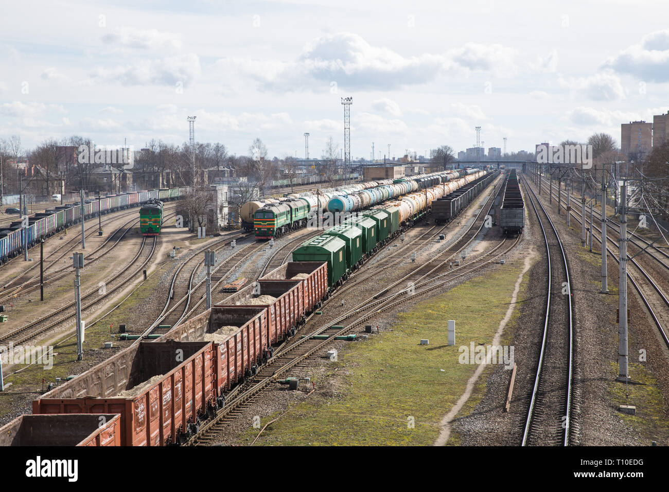 City Riga, Latvia. Railway with cargo locomotive with wagons. Many iron ...