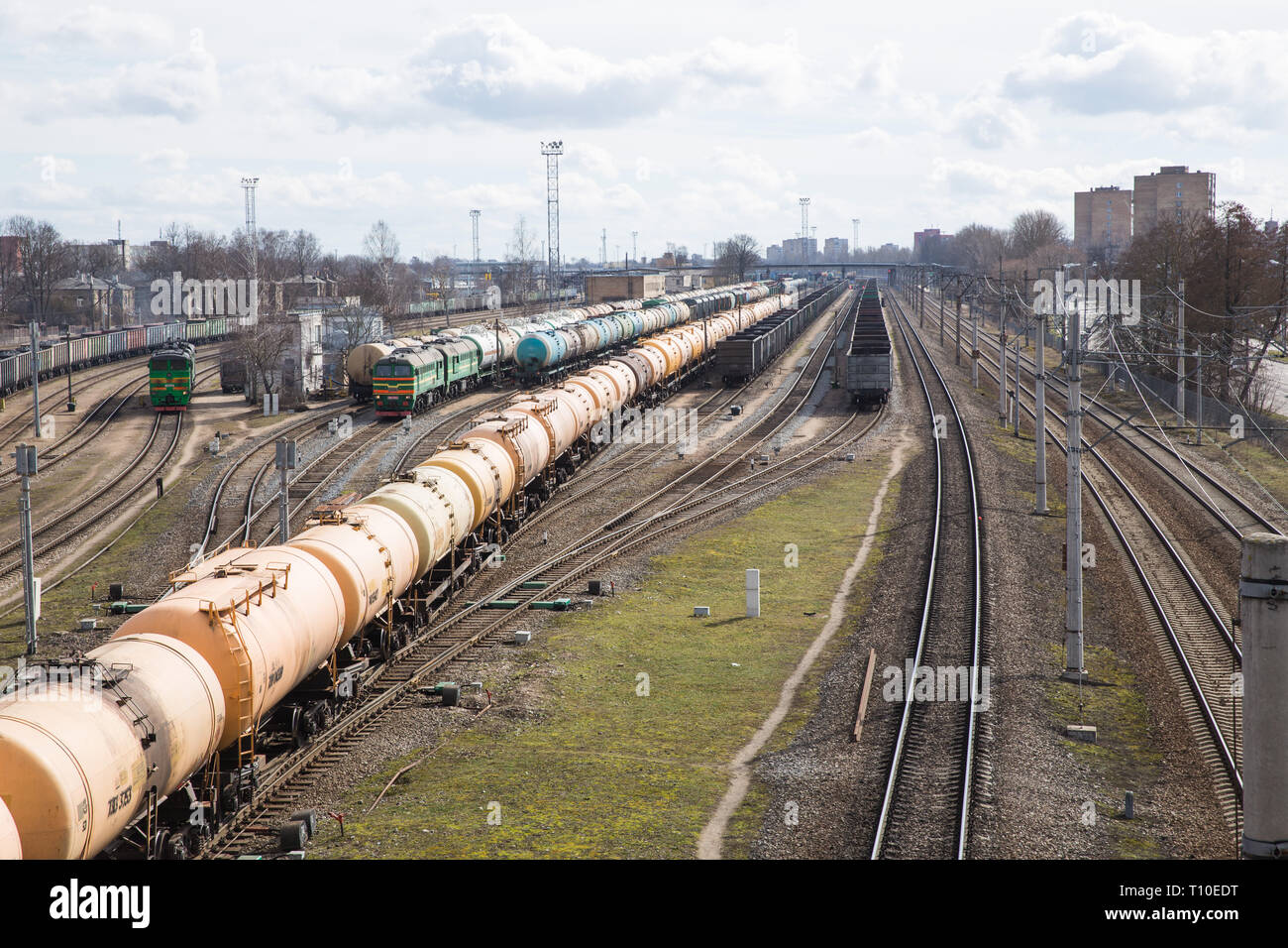 City Riga, Latvia. Railway with cargo locomotive with wagons. Many iron ...