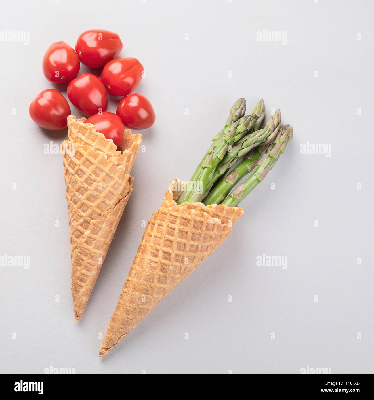 Healthy fresh vegetables in waffle cones on grey background. Vegan and ...