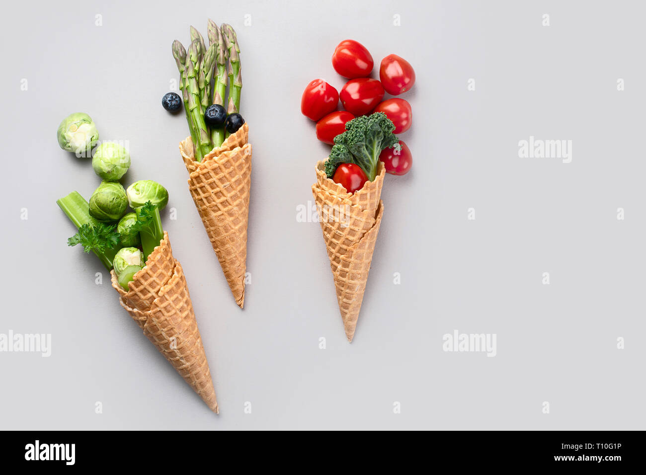 Healthy fresh vegetables in waffle cones on grey background. Vegan and ...