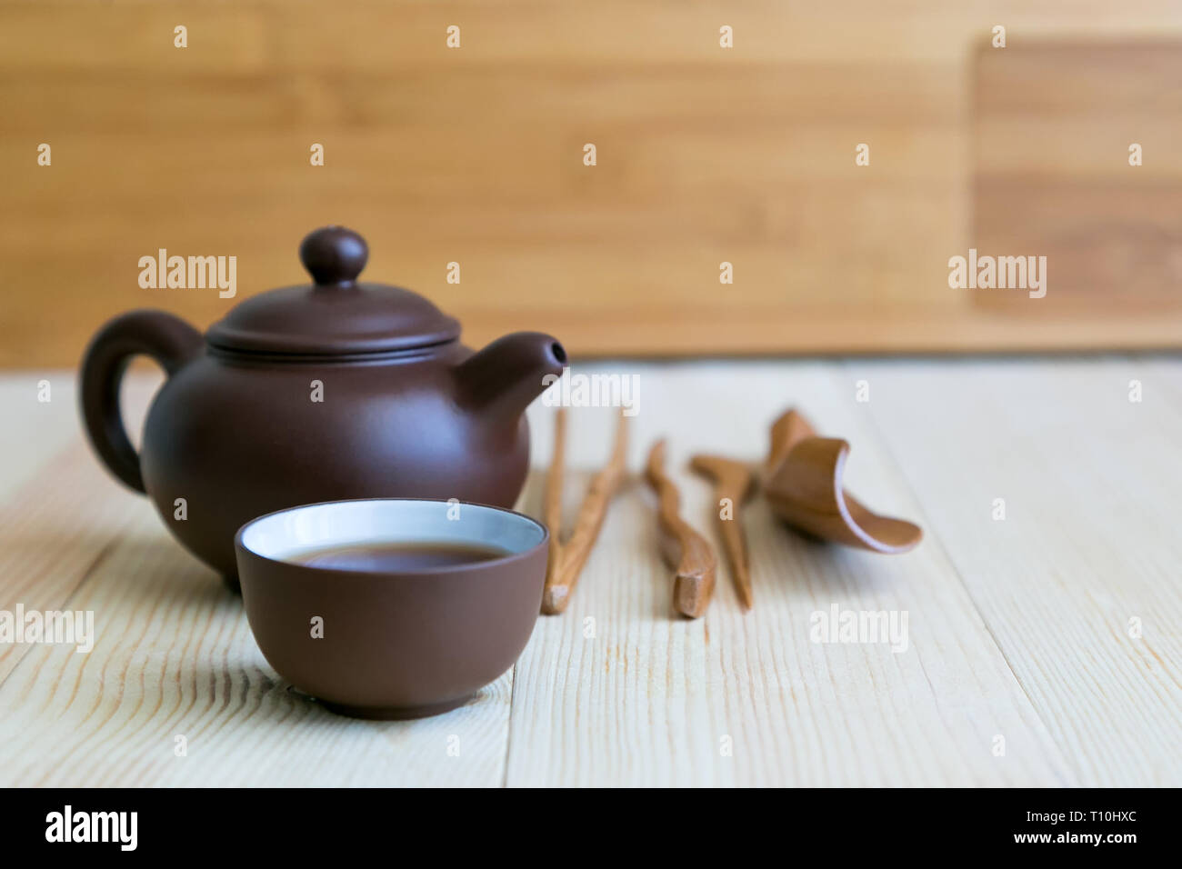 Dishes for tea and wooden sticks on a light background Stock Photo - Alamy