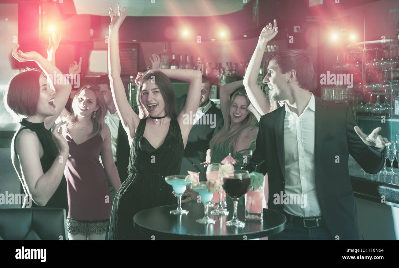 Young students dancing on event with cocktails in the club Stock Photo ...