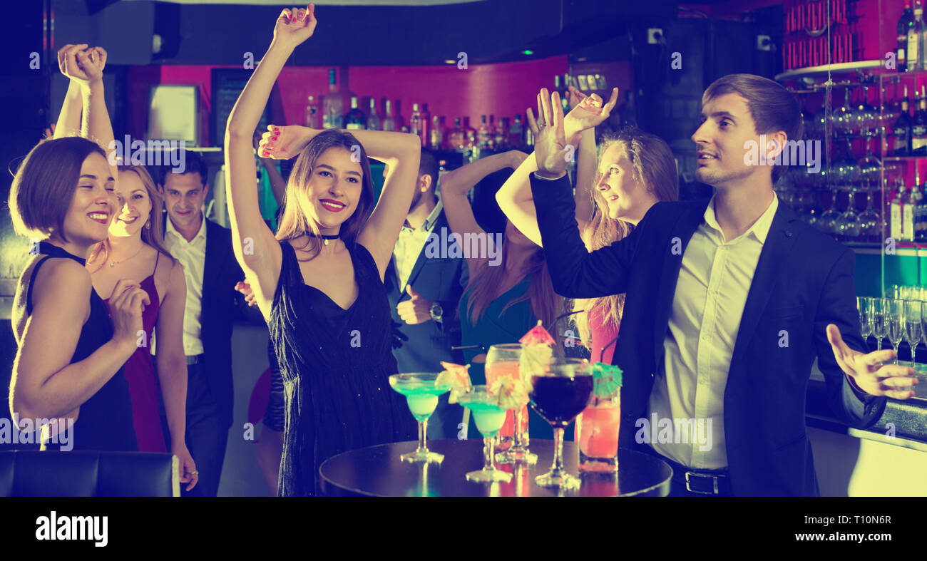 Happy friendly smiling glad colleagues dancing on corporate party with ...